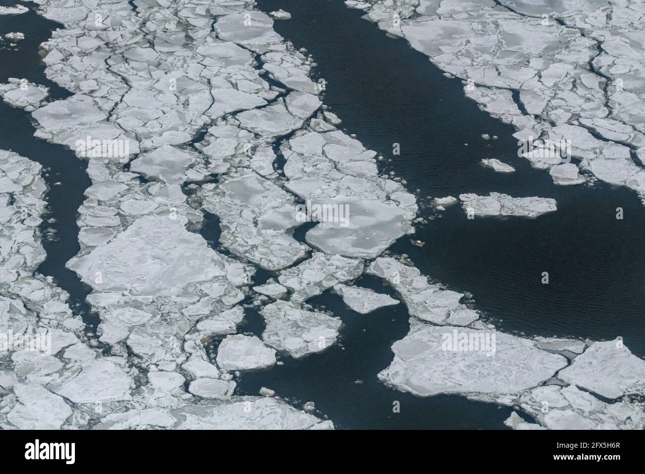 Stunning abstract view of sea ice that is partially frozen from above ...