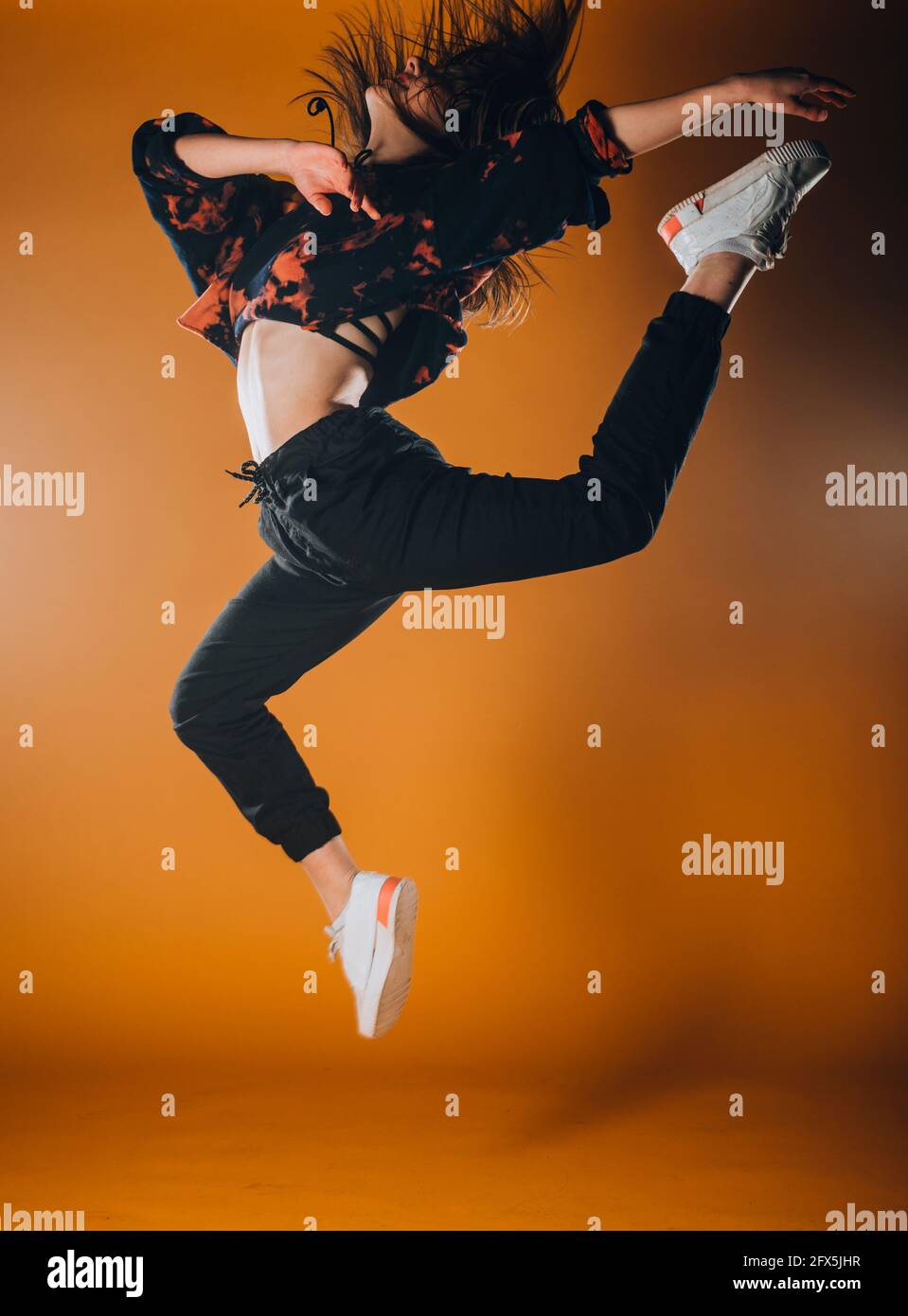 Modern dancing performer jumping exercising during a dance practice ...
