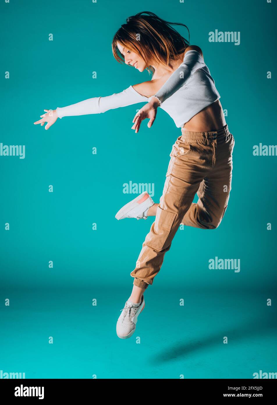 Slender flexible dance performer during a dance practice in modern ...