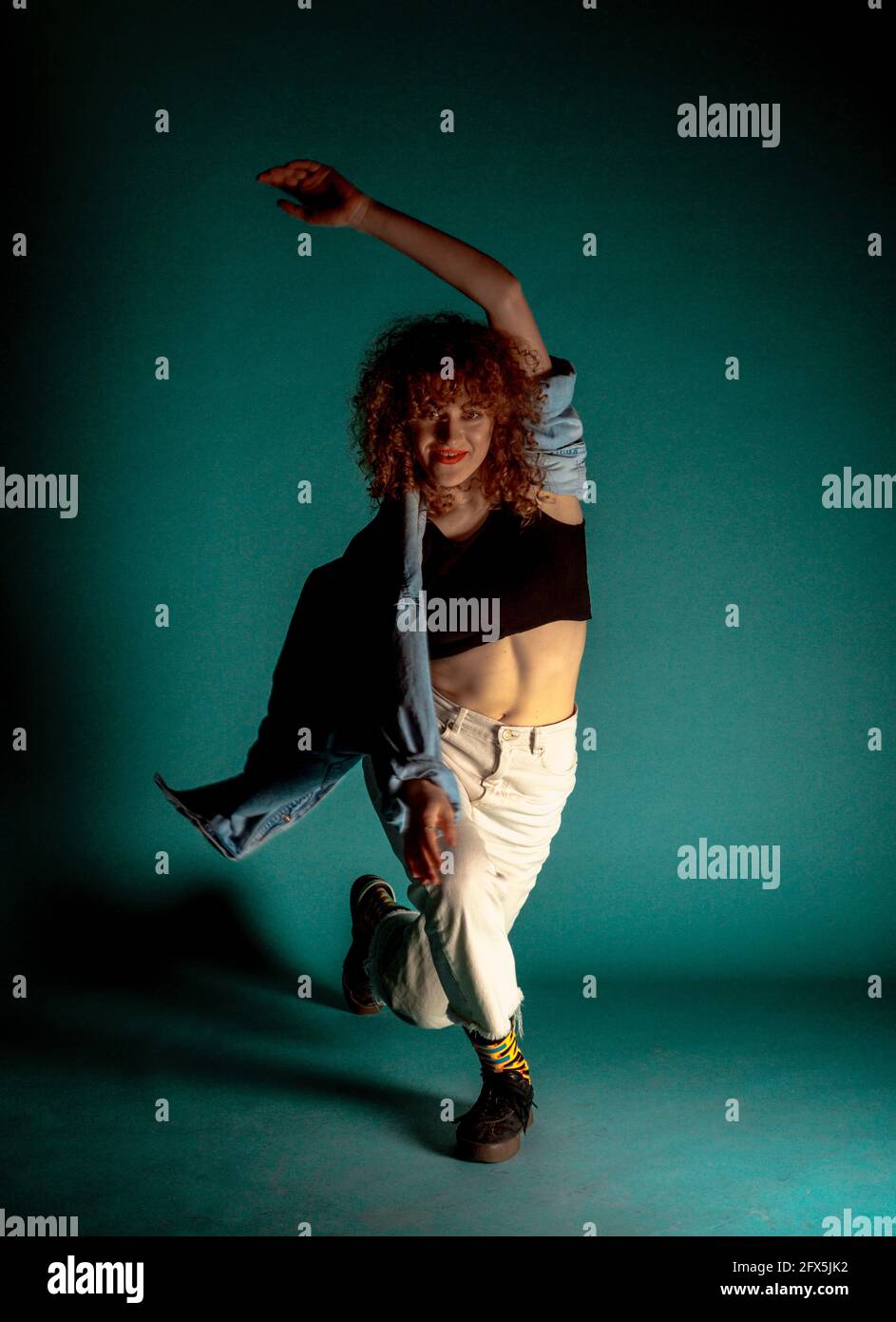 Artistic dance moves performed by an young girl with curly hair Stock ...
