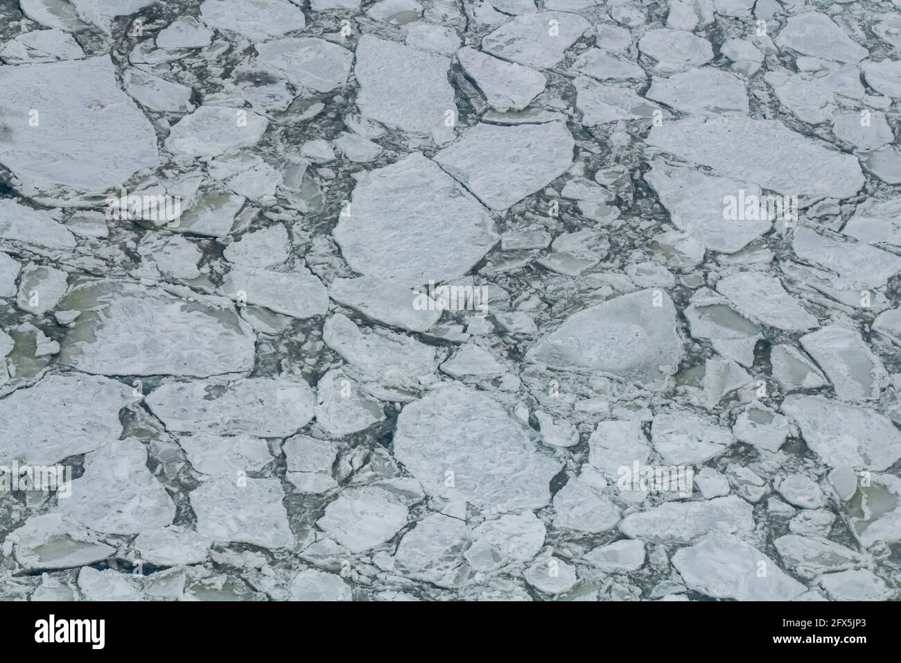 Stunning abstract view of sea ice that is partially frozen from above ...