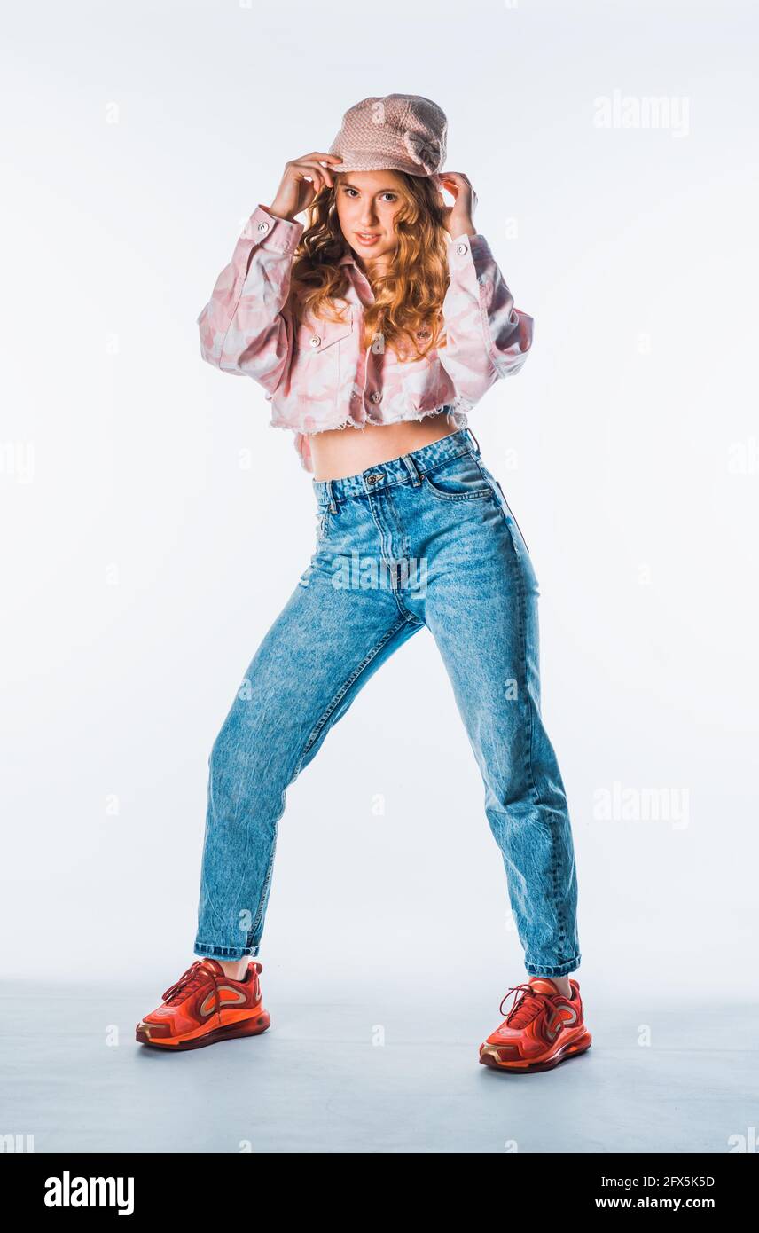 Body shot of an attractive female model posing in modern style clothes ...