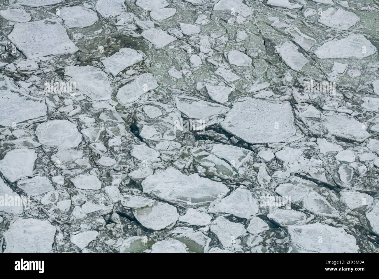 Stunning abstract view of sea ice that is partially frozen from above ...
