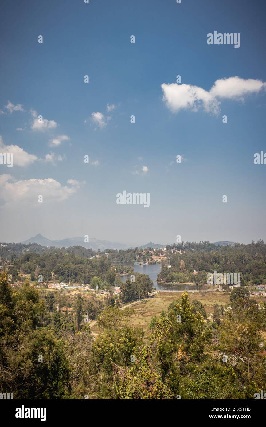 This is the upper lake view with green forest and blue sky. This image ...