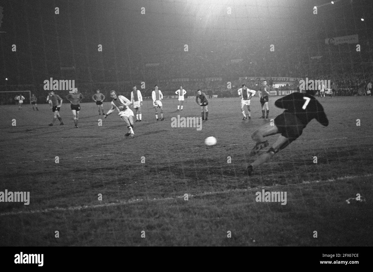 Henk Groot takes a penalty and scores: 3-0. Goalkeeper Rynio dives in ...