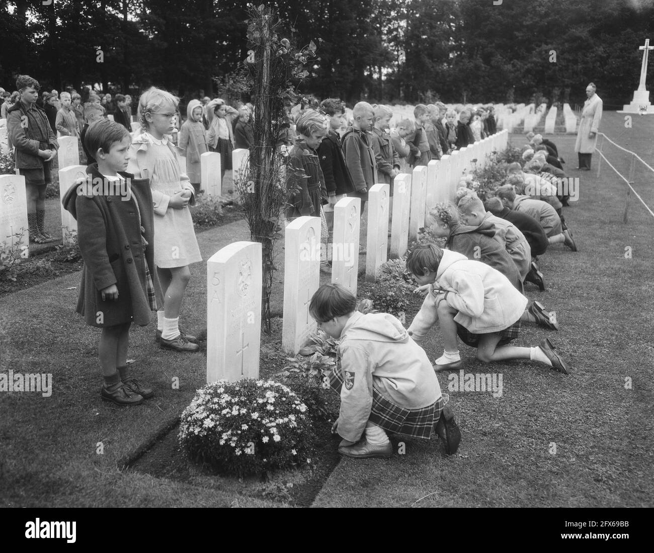 Schoolchildren decorating graves hi-res stock photography and images ...