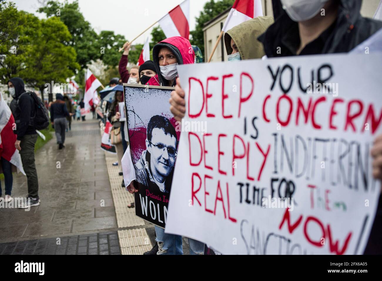 Protesters hold placards and wave the forbidden historical flag during ...