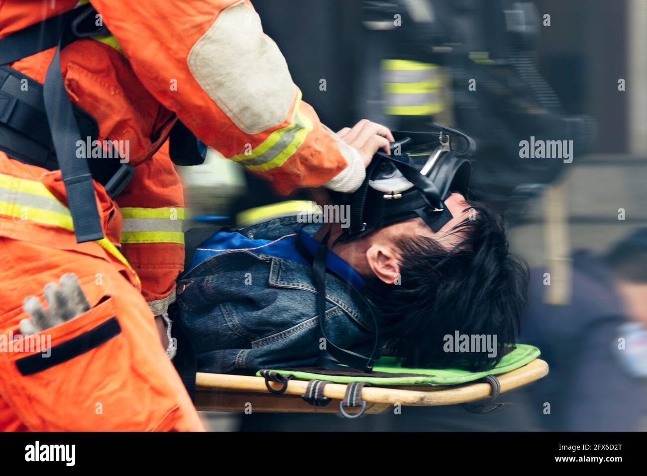 The rescue workers move hurt person with a stretcher Stock Photo - Alamy