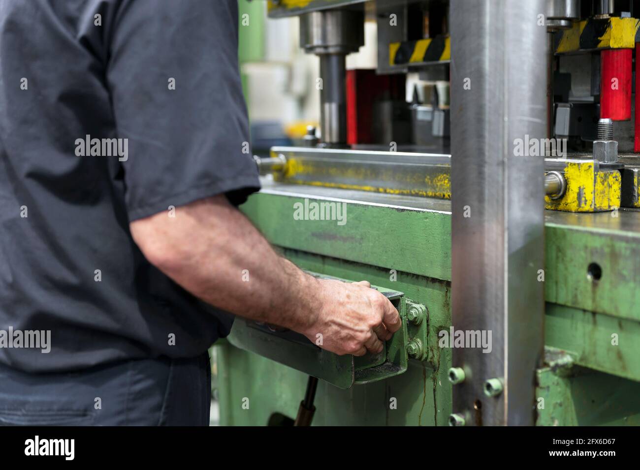 Steel Manufacturing Plant. A Worker is Placing a Piece of Metal Inside ...