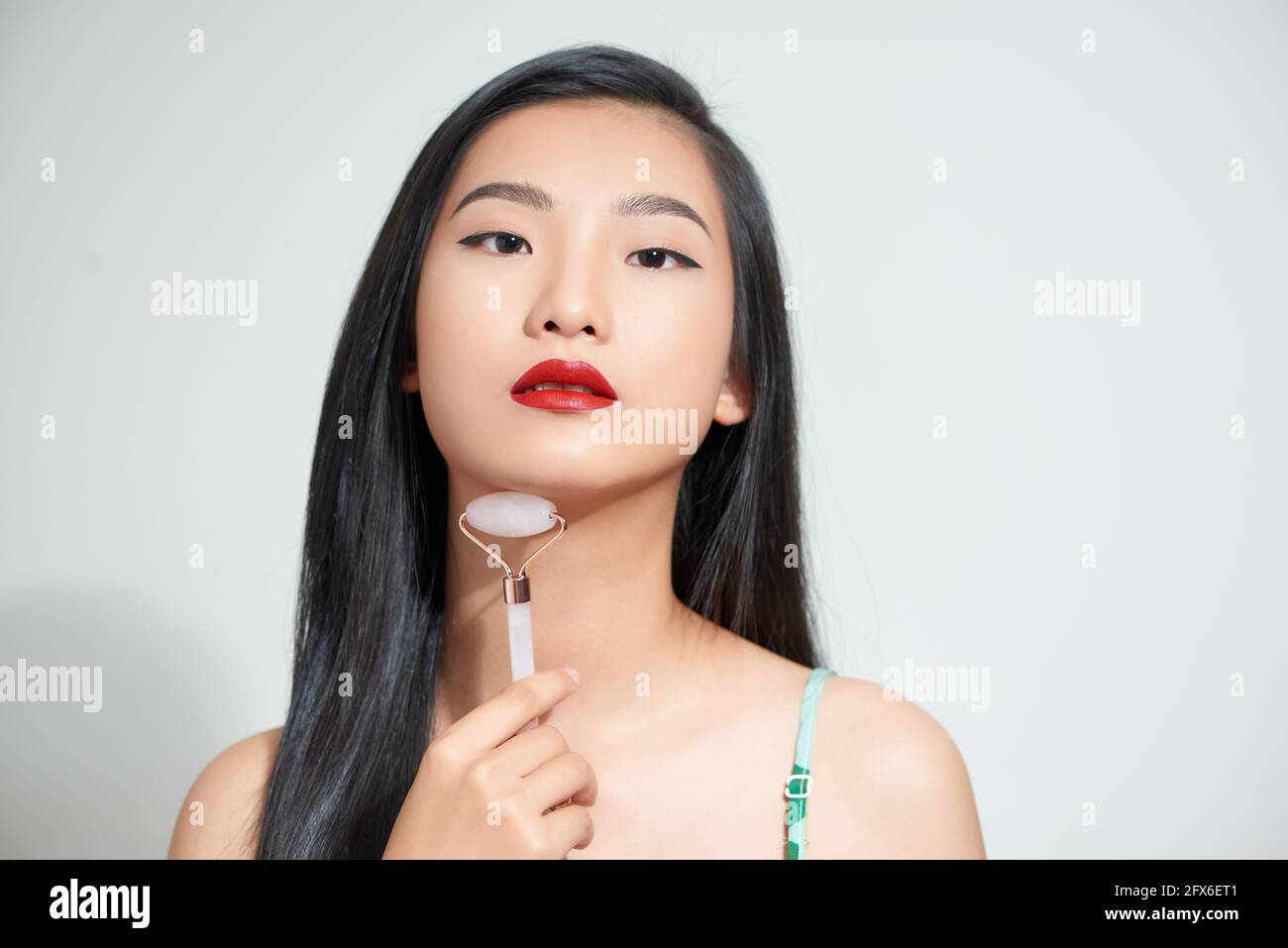 Close up photo of a young woman looking relaxed and smiling while using ...