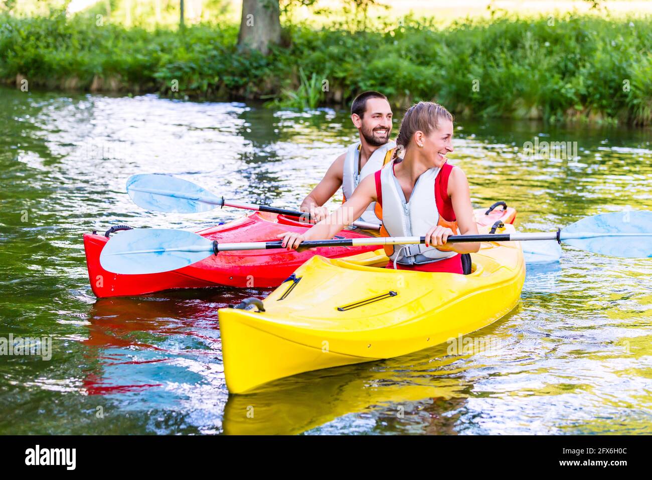 Friends going down river in sport canoe Stock Photo - Alamy