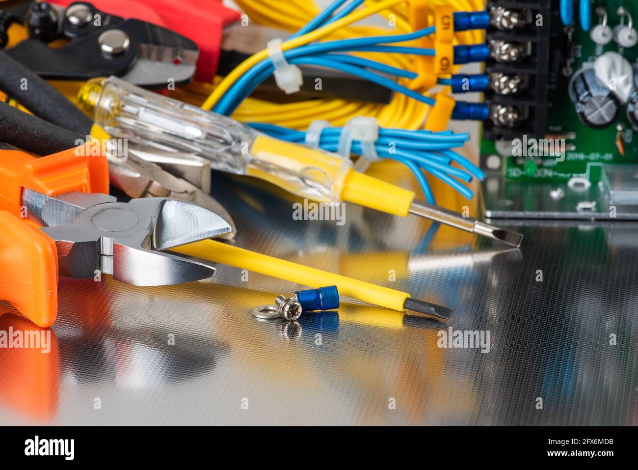 Set of electrician tools and equipment on a metal background, closeup ...