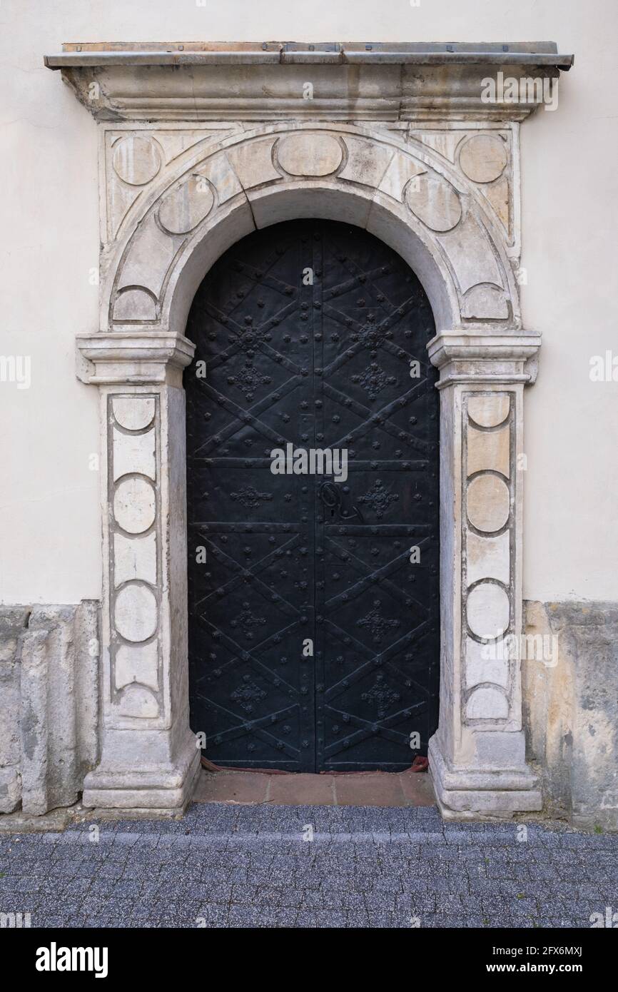 Old steel door with decorative stone portal Stock Photo - Alamy