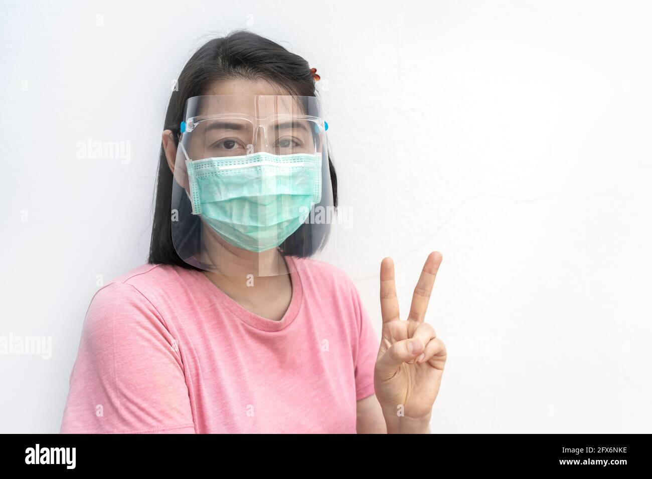 Isolated portrait of Asian woman wearing medical facial mask and face ...