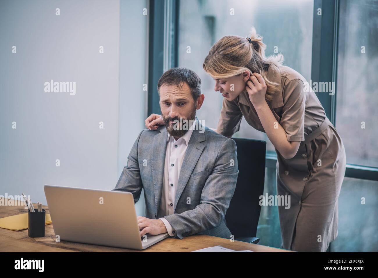 Scared boss and leaning woman talking smiling Stock Photo - Alamy