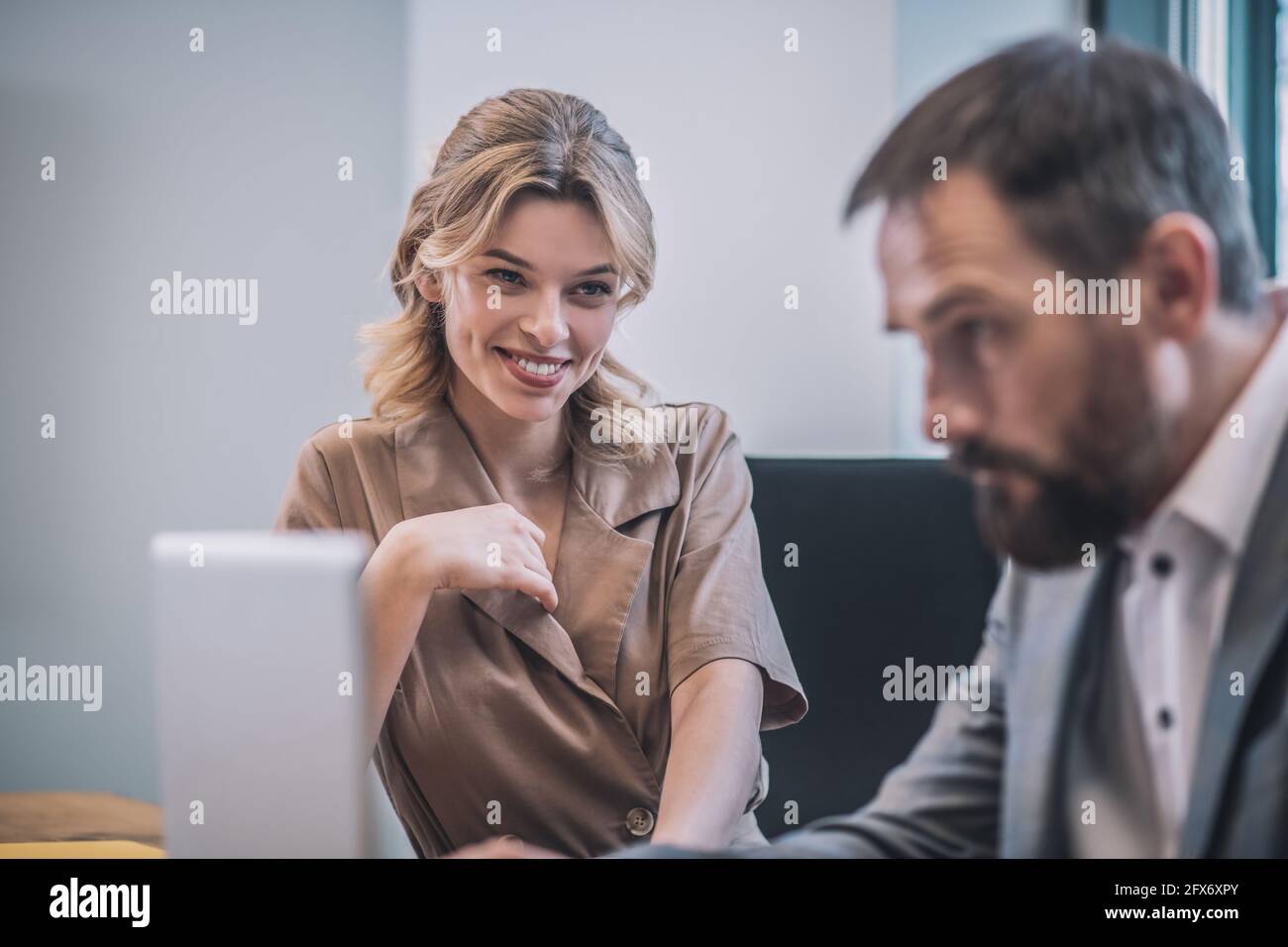 Concerned smiling woman and serious business man Stock Photo - Alamy