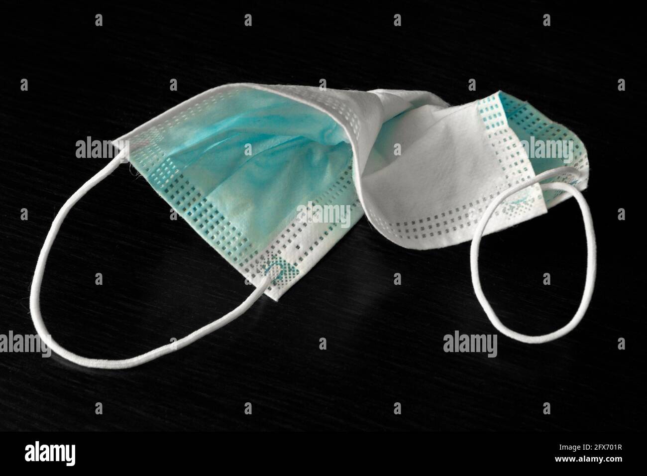 A used medical face mask protecting against respiratory diseases ...