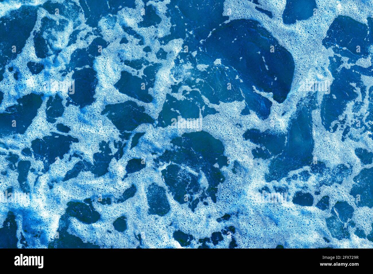 Areal shot of deep blue and rough sea with lot of sea spray.Blue ...
