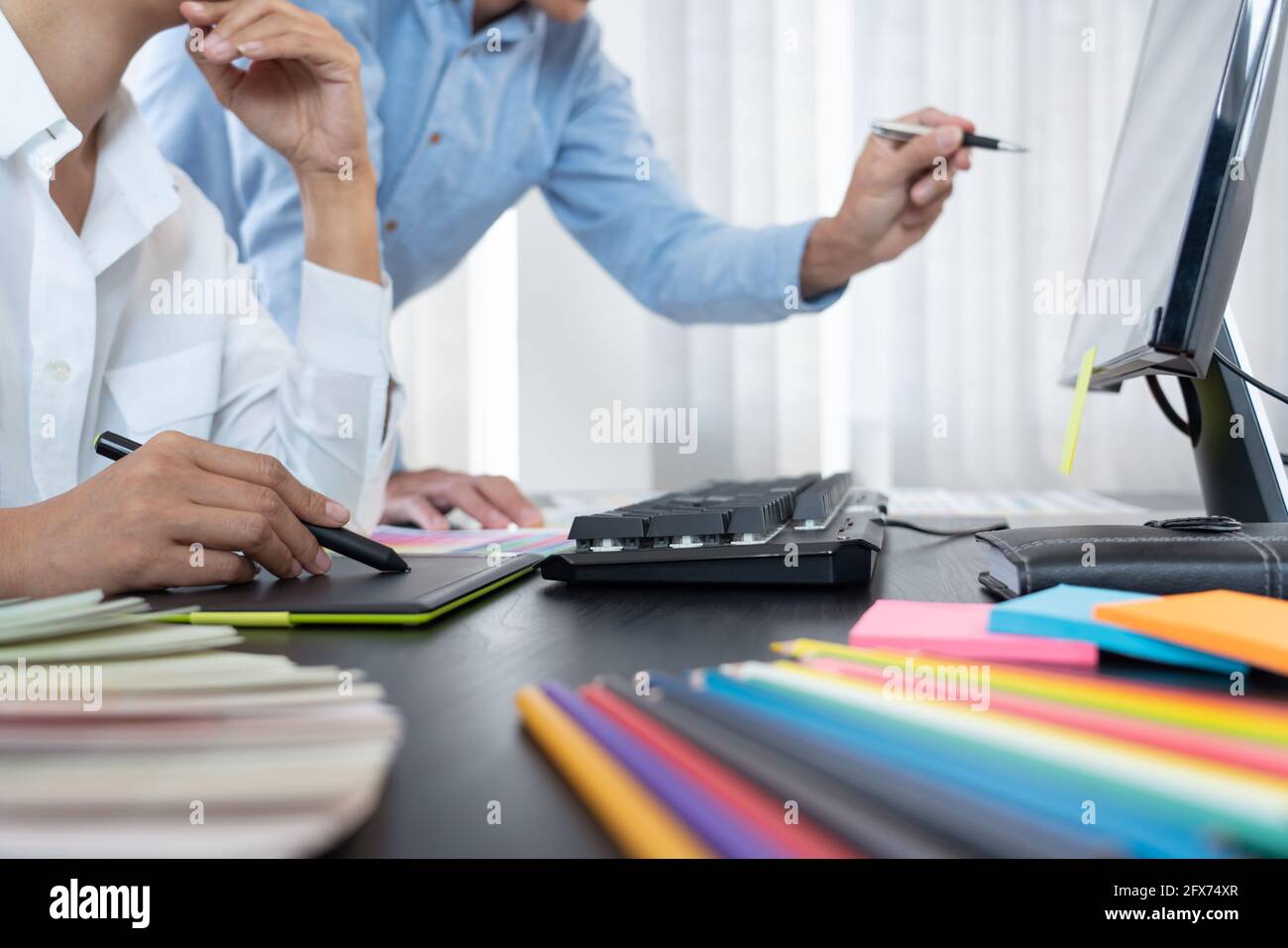 graphic designer team working on web design using color swatches ...