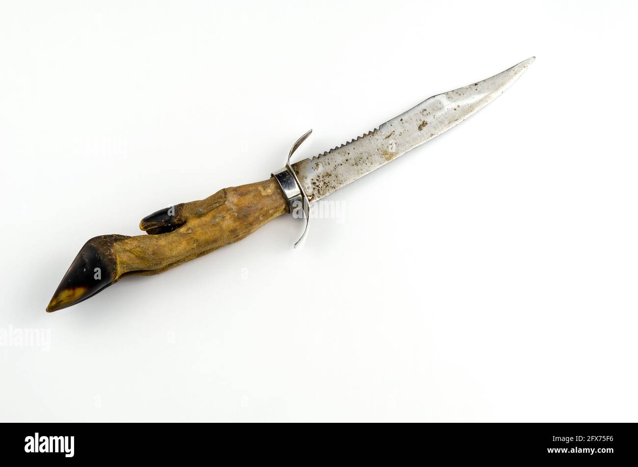 An old hunting knife made from a goat's hoof on the white background ...