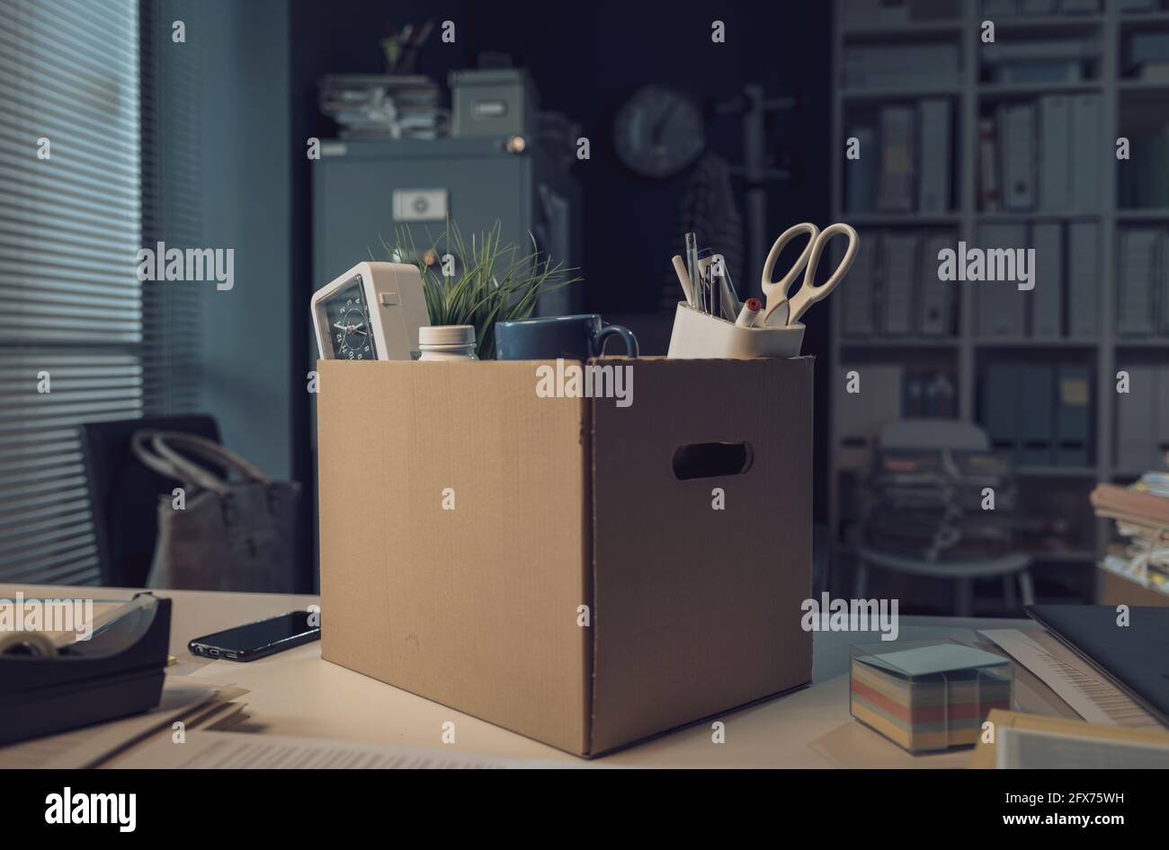 Office worker belongings in a carton box: job dismissal and crisis ...