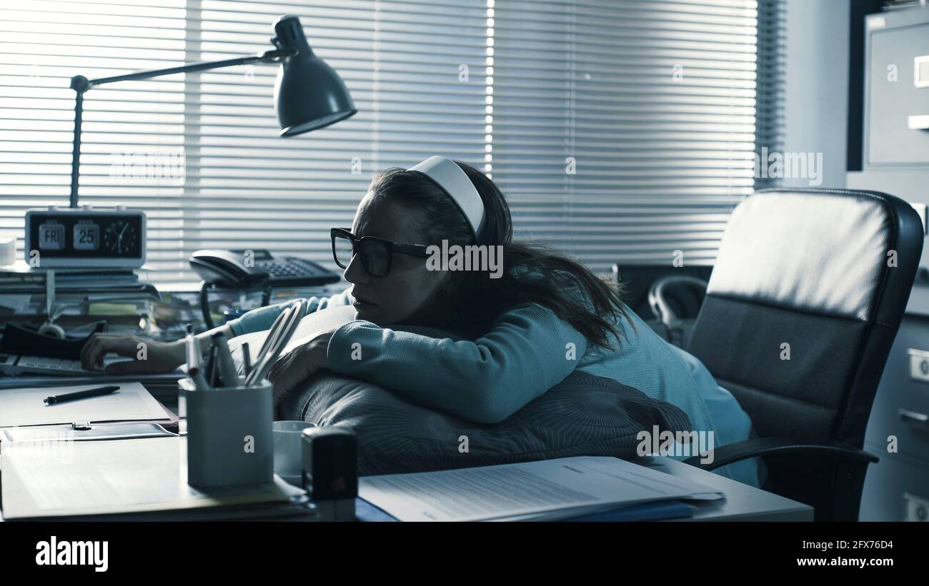 Frustrated tired office worker leaning on the desk and thinking Stock ...