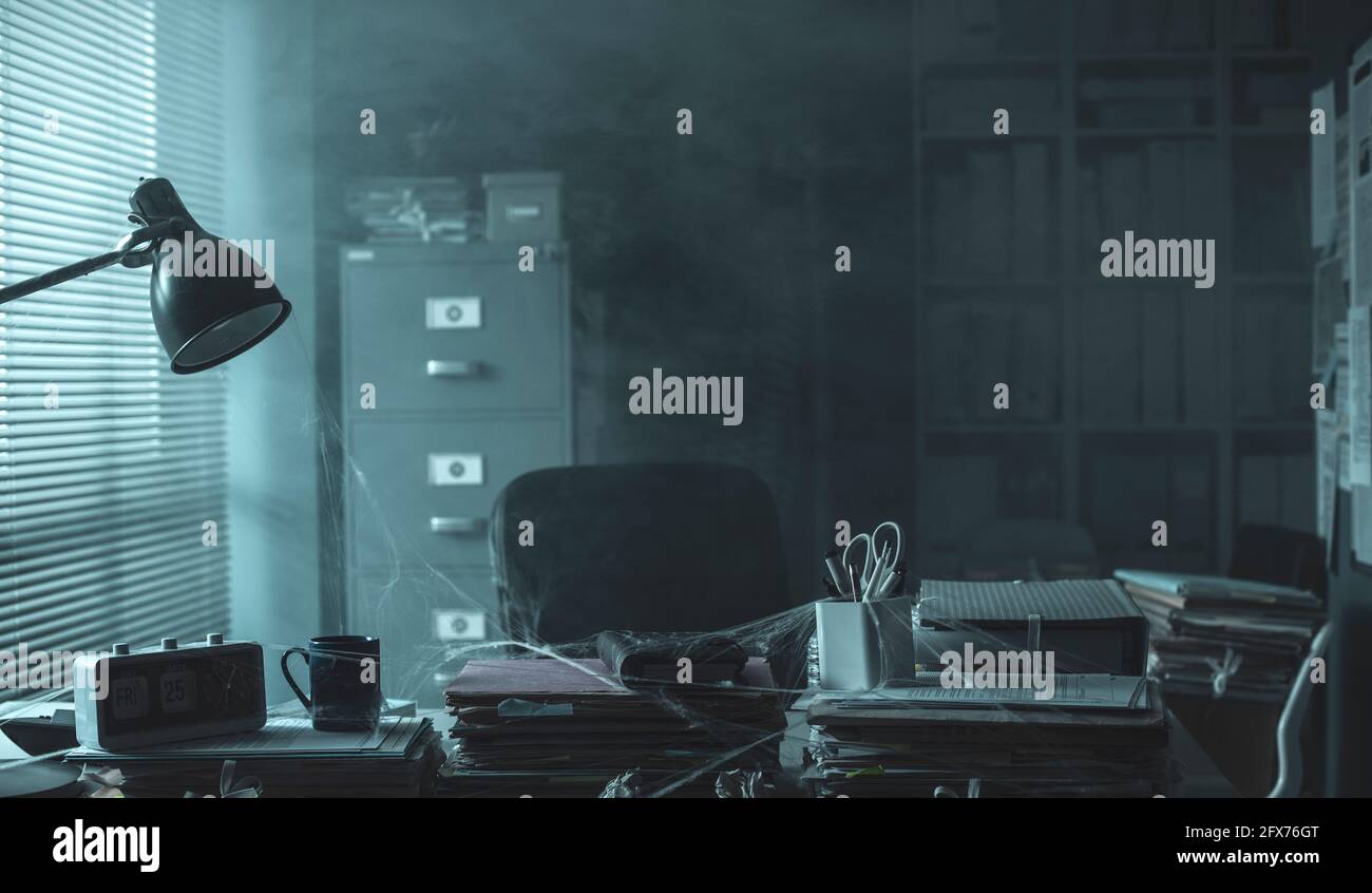 Messy abandoned office after company shut down: the desk is cluttered ...