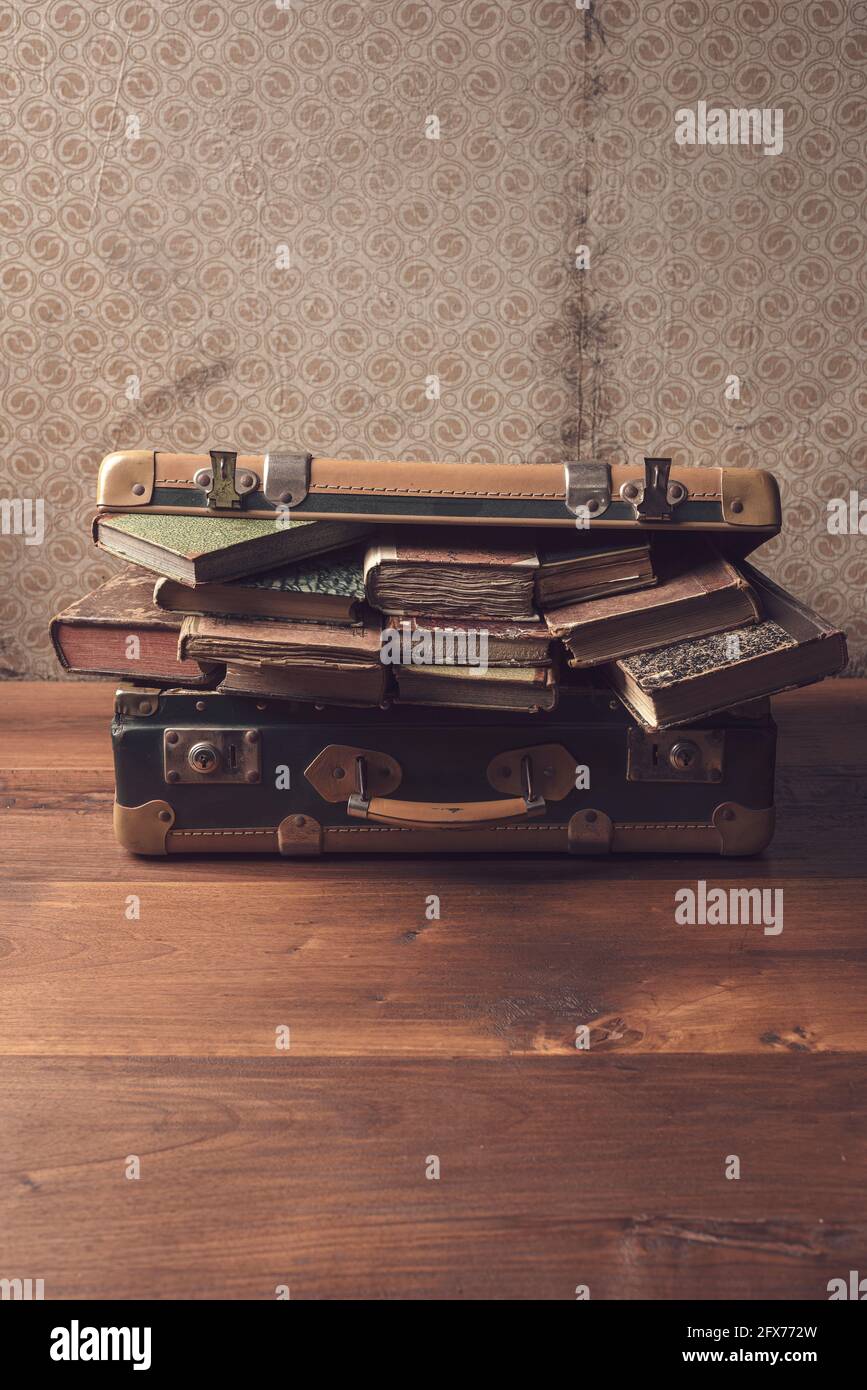 Old leather suitcase with books on the floor. Suitcase in retro style ...