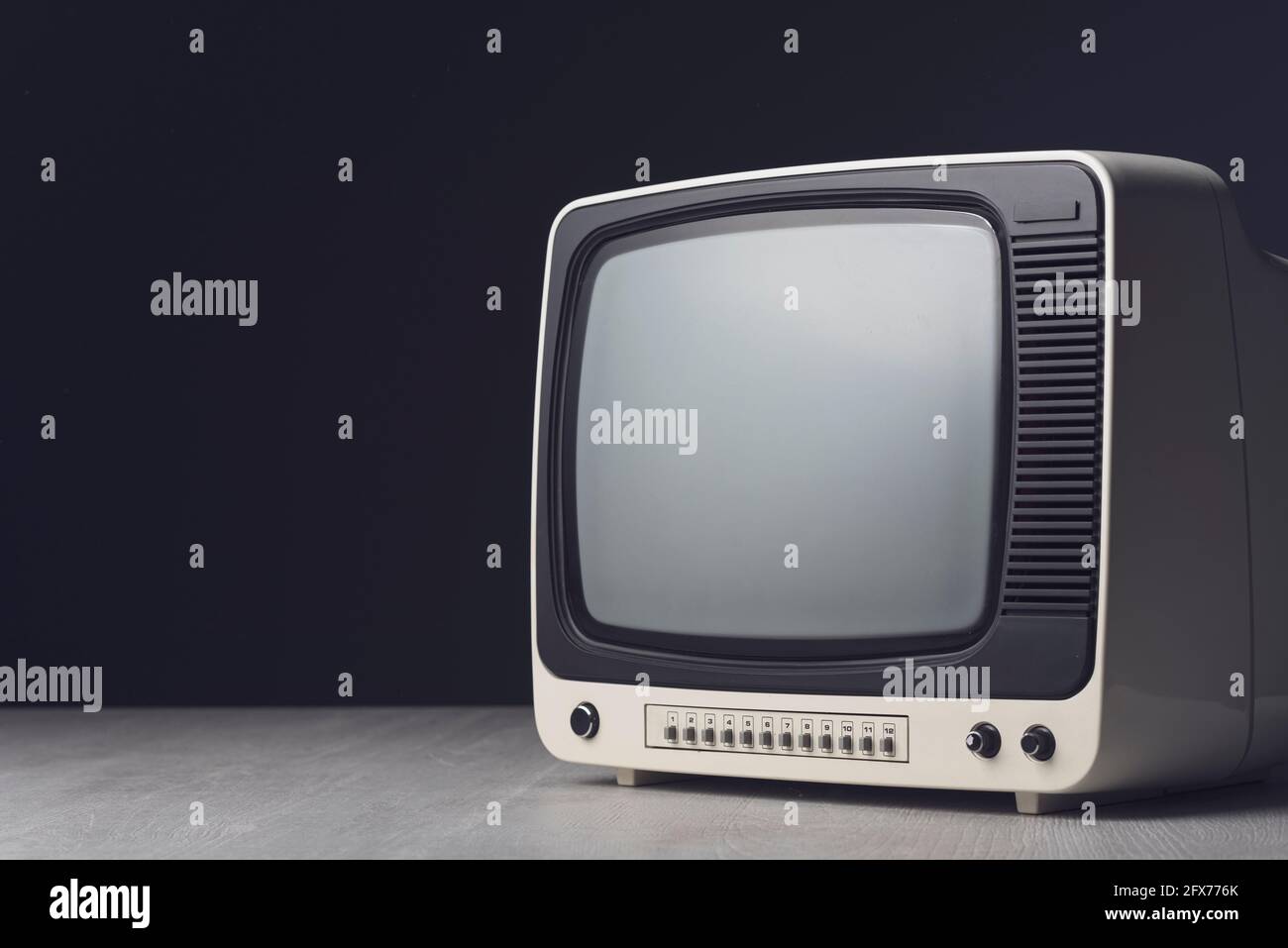 Retro white old tv on table on dark background, copy space Stock Photo ...