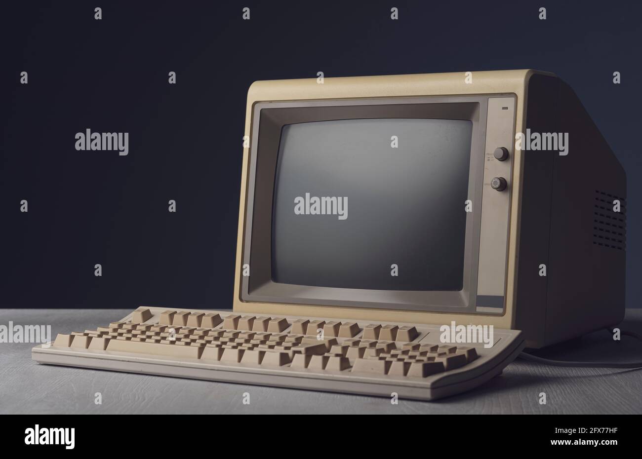 Vintage personal computer with keyboard on a desktop, outdated ...