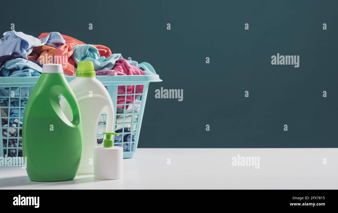 Green detergents and laundry basket: eco friendly laundry concept Stock ...