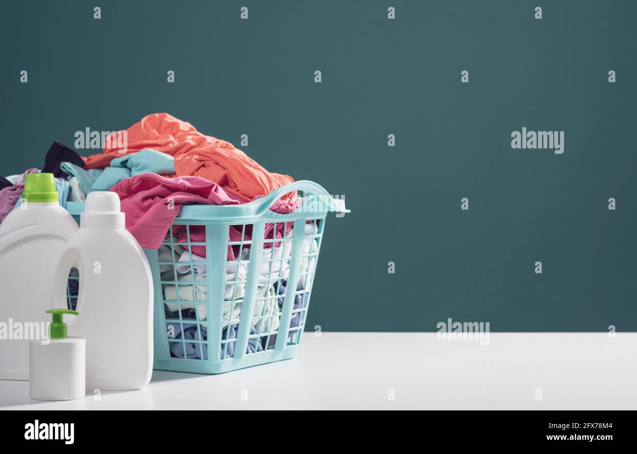 Green detergents and laundry basket: eco friendly laundry concept Stock ...