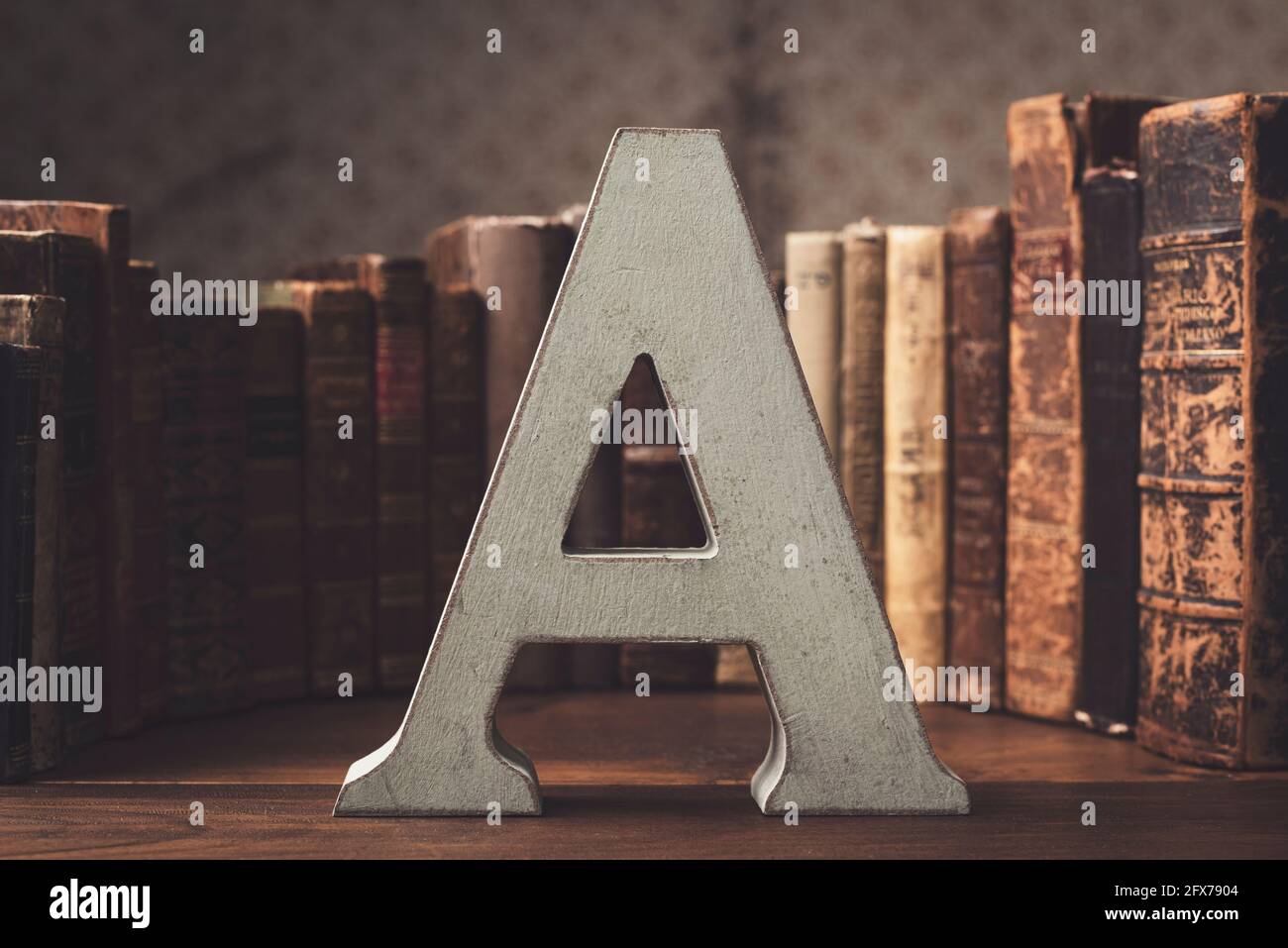 Big letter A and collection of ancient books, knowledge and education ...
