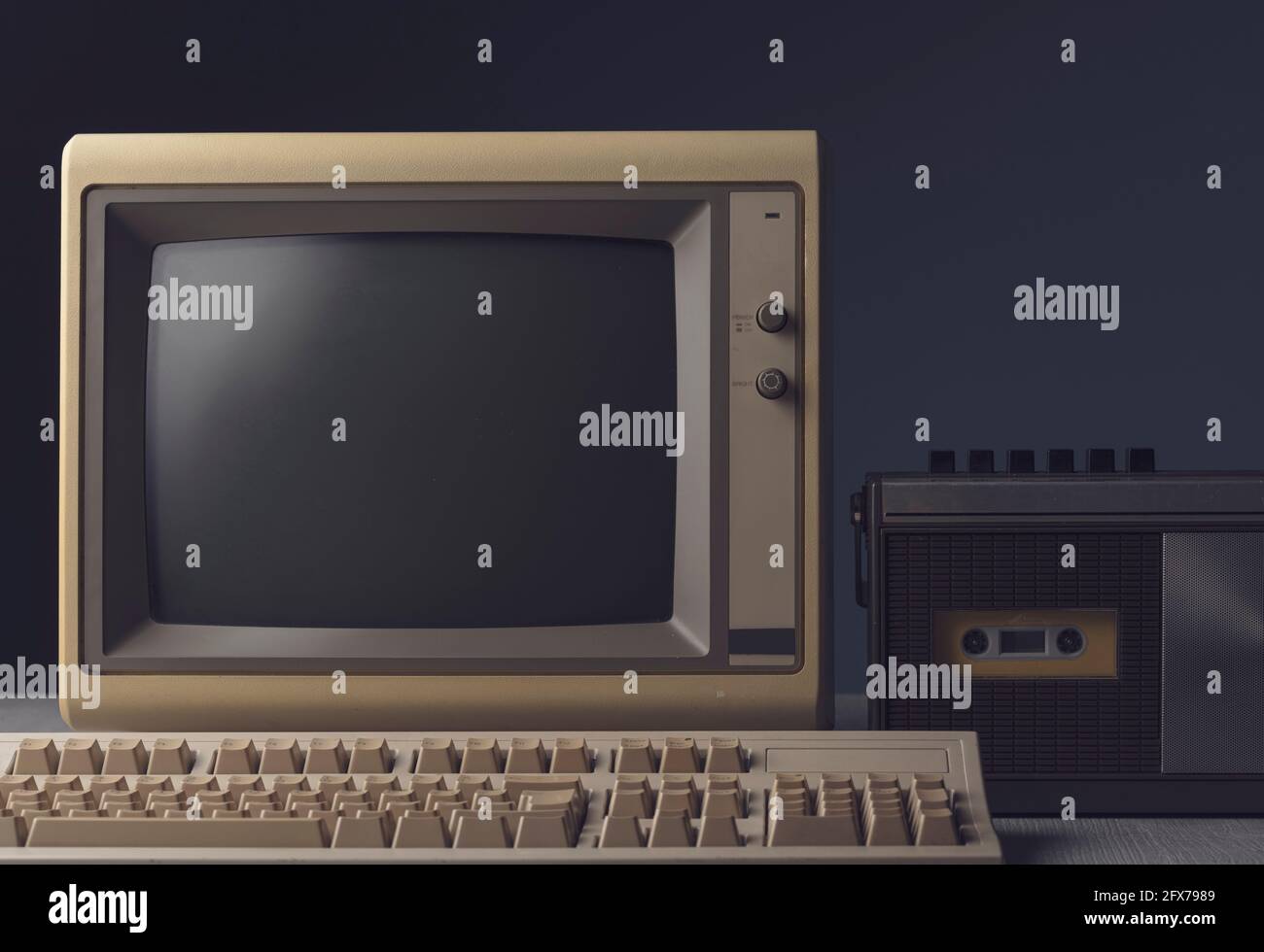 Vintage personal computer and cassette player on a desktop, outdated ...