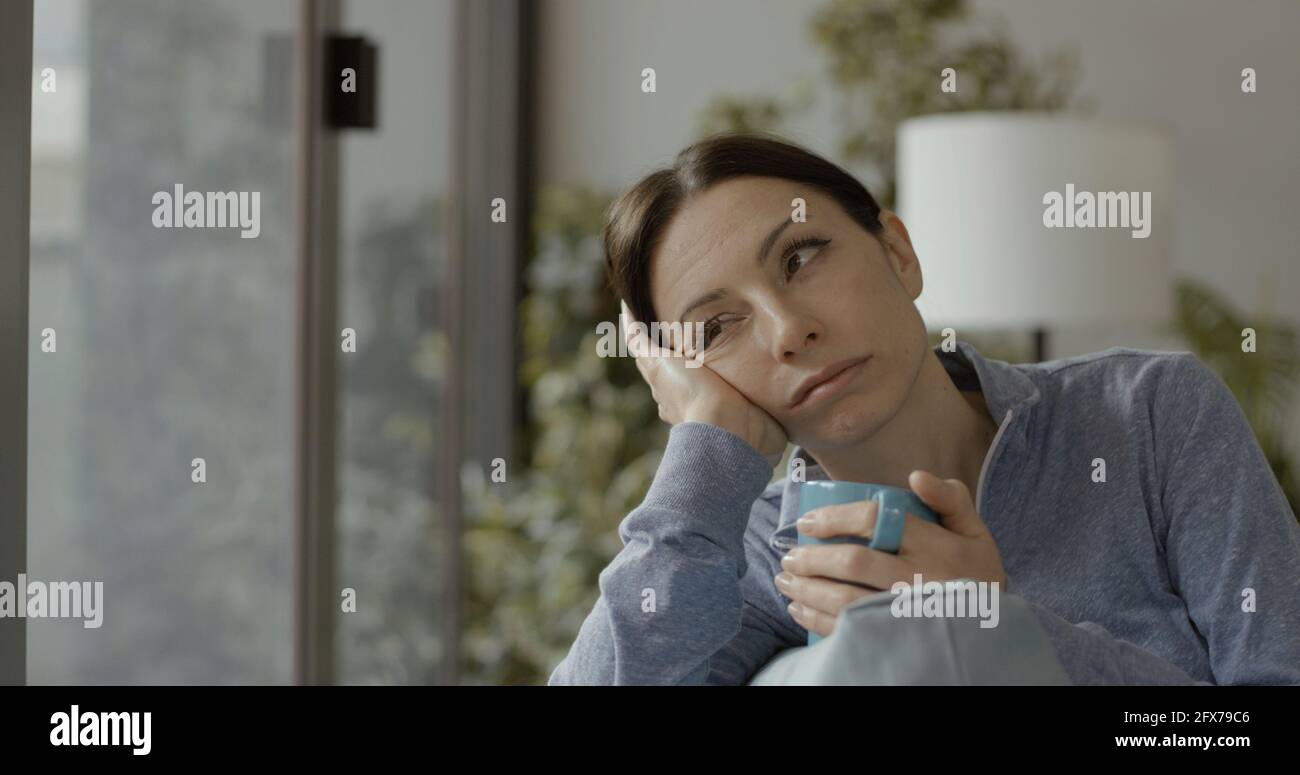 Scared woman looking out of window hi-res stock photography and images ...