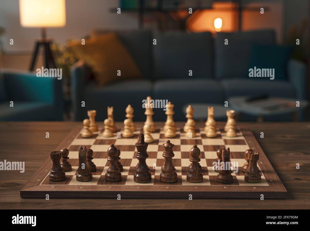 Chess board ready for the game on the table and living room interior in ...