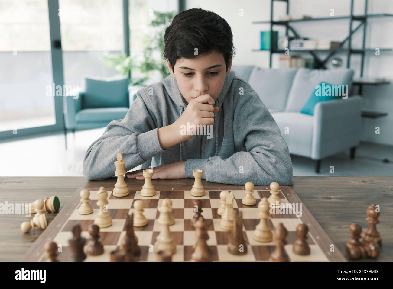 Smart kid learning chess game at home, he is focused and thinking Stock ...