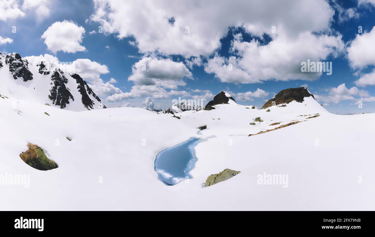 Small alpine lake comes out of the thaw in spring Stock Photo - Alamy