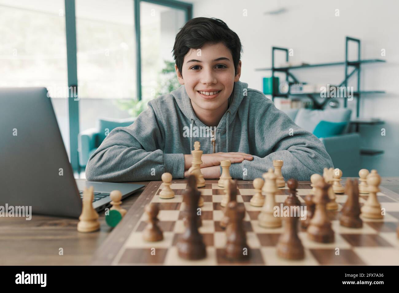 Happy young boy learning chess at home, he is smiling at camera Stock ...