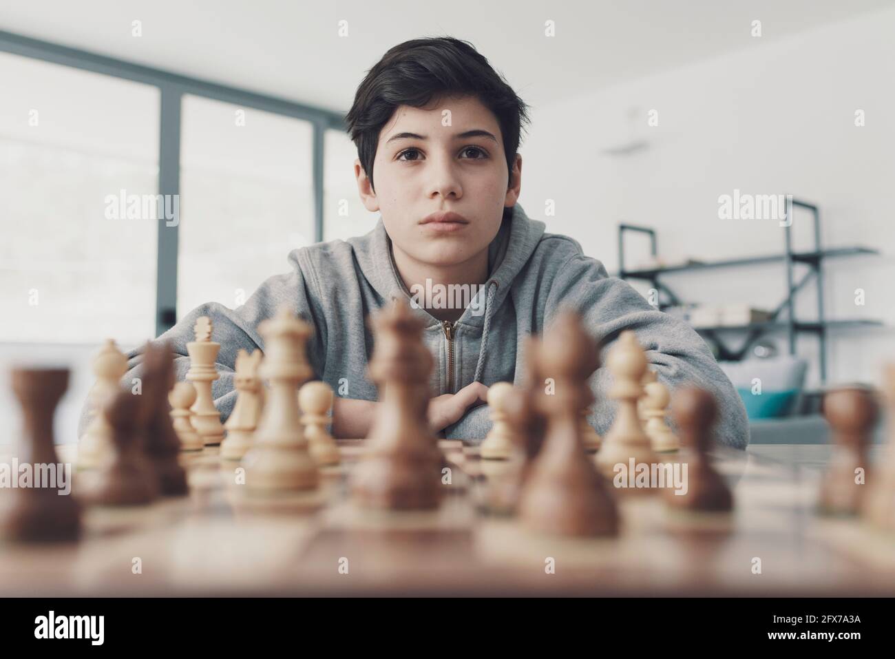 Smart kid learning chess game at home, he is focused and thinking Stock ...