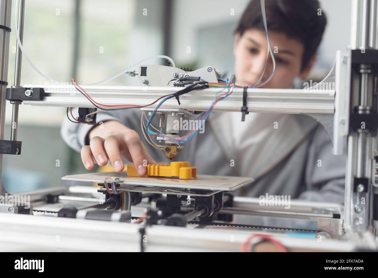 Smart boy printing a prototype using a 3D printer, science and ...