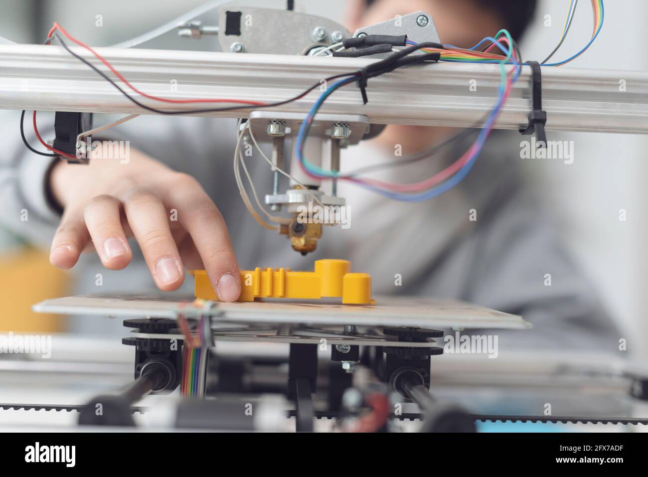 Smart boy printing a prototype using a 3D printer, science and ...