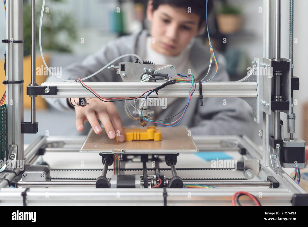 Smart boy printing a prototype using a 3D printer, science and ...