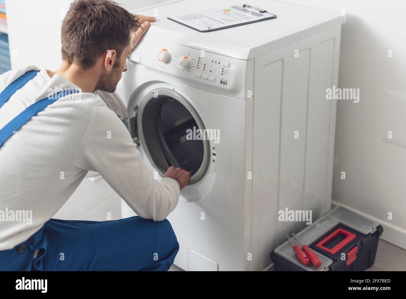 Technician checking washing machine hi-res stock photography and images ...