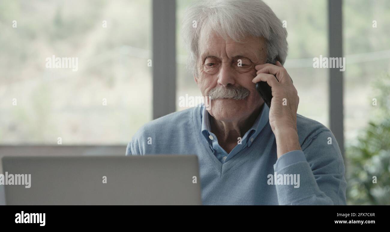 Senior man receiving phone call hi-res stock photography and images - Alamy