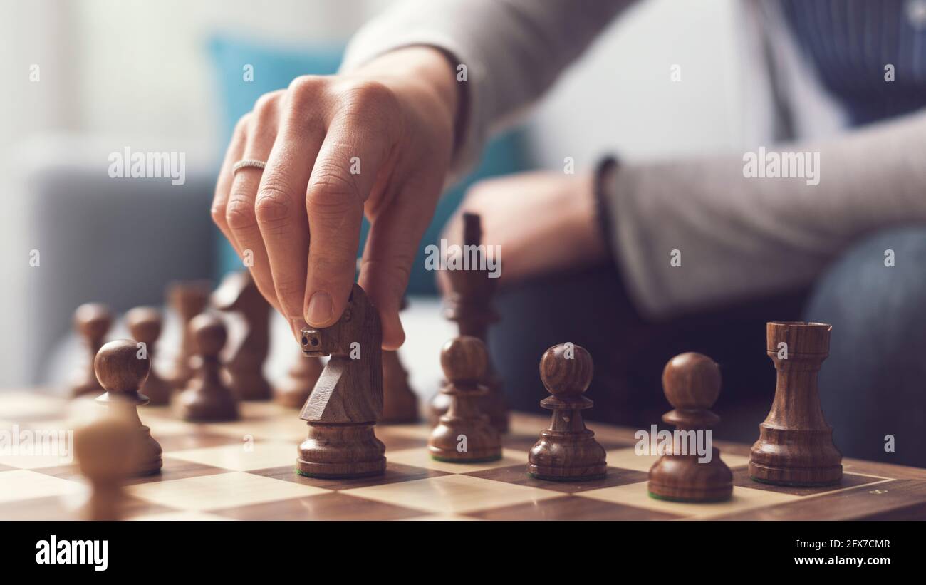 Woman moving chess piece hi-res stock photography and images - Alamy