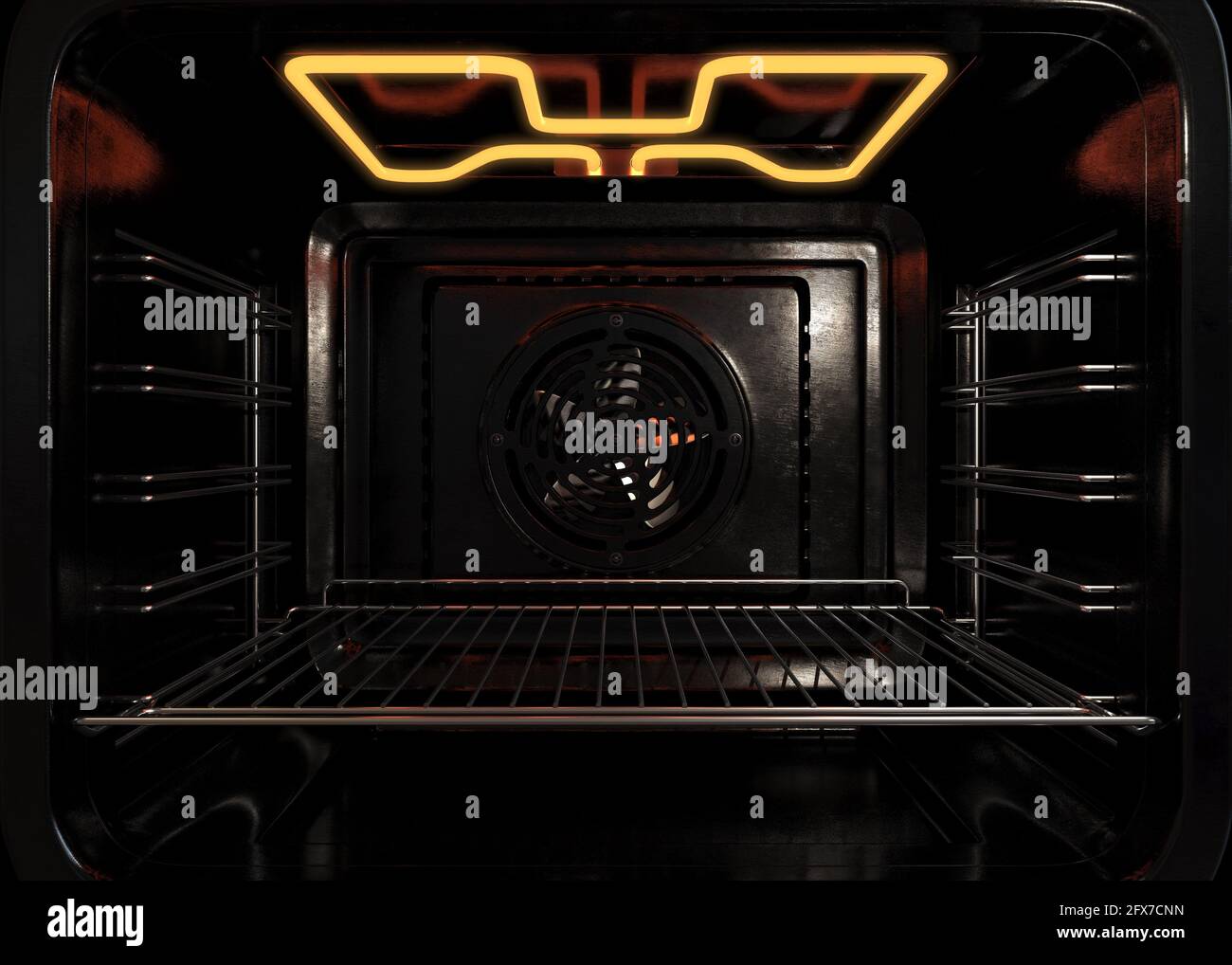 An upclose view of the inside of an empty operational household oven ...