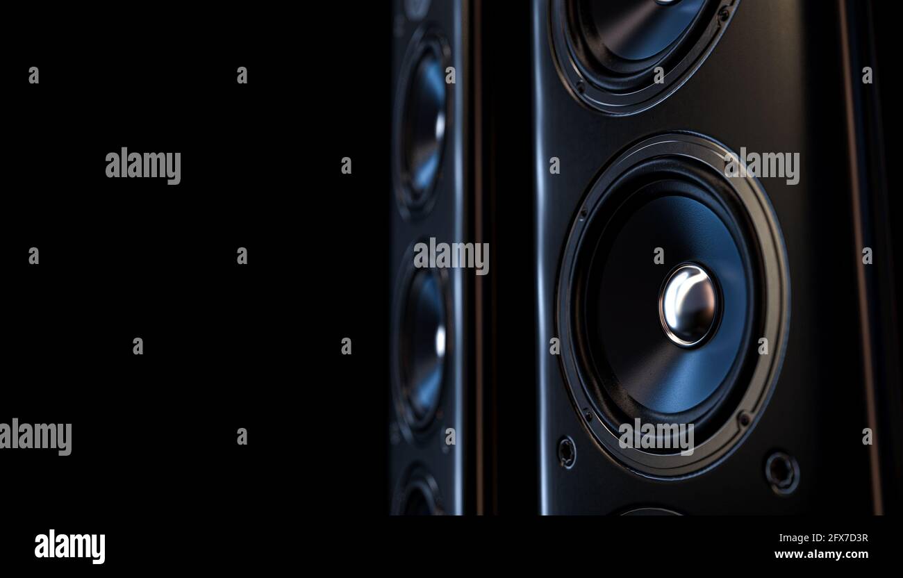 A modern surround sound speaker arrangment on a dark backlit studio ...
