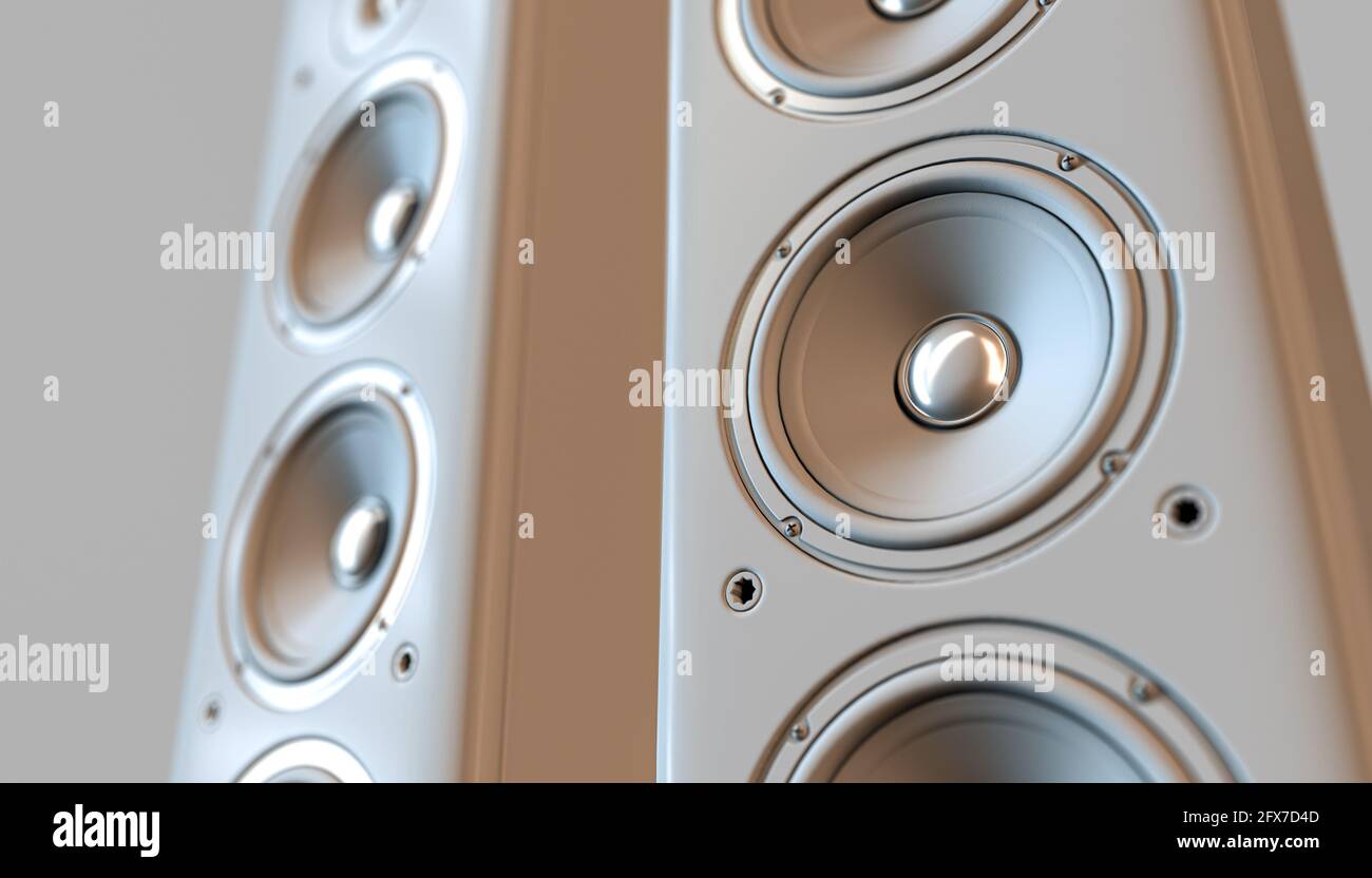 A modern white surround sound speaker arrangment on a light backlit ...