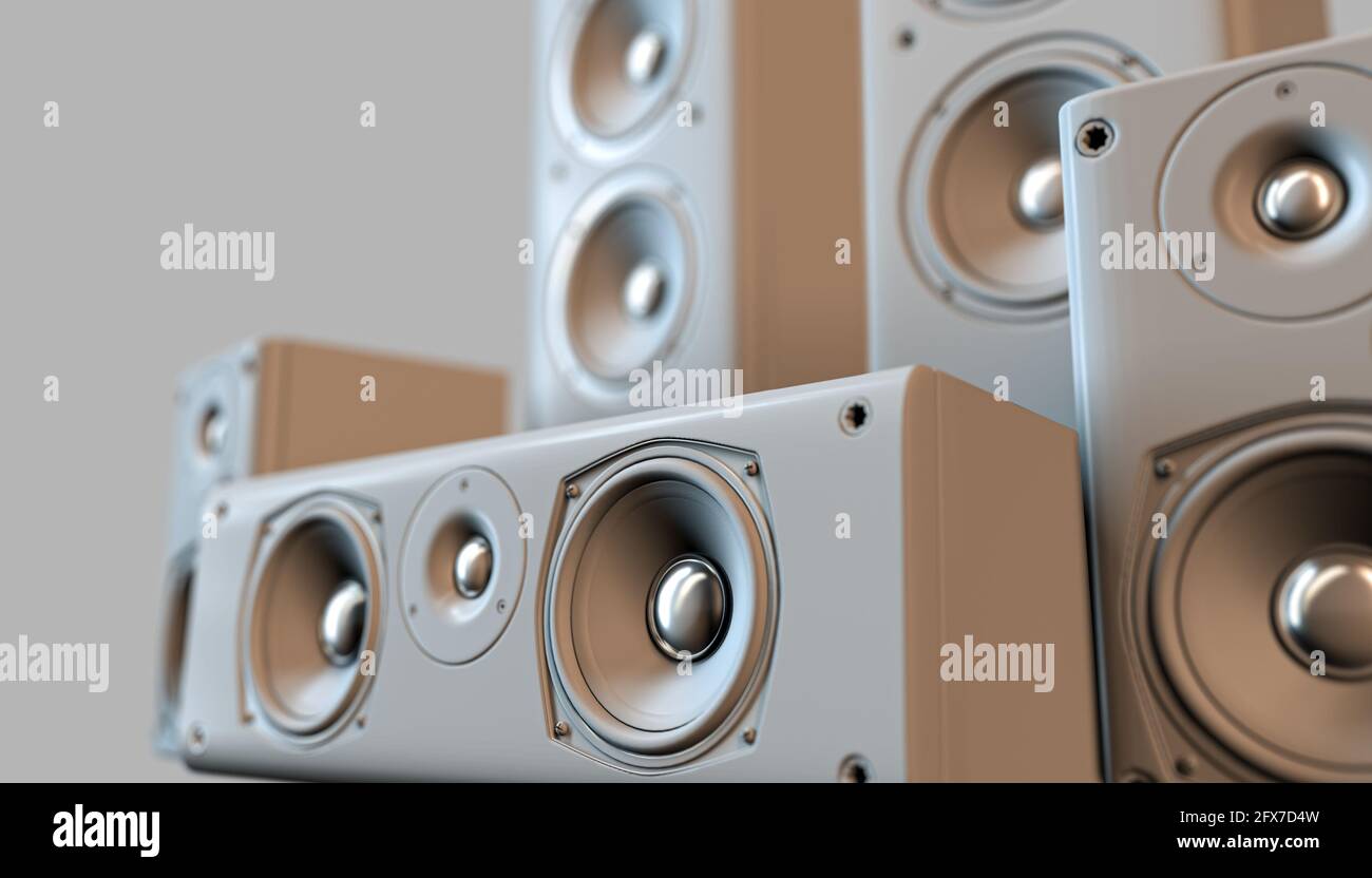 A modern white surround sound speaker arrangment on a light backlit ...